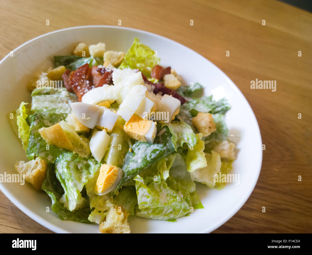 caesar salad placed on top of a wooden table Stock Photo - Alamy