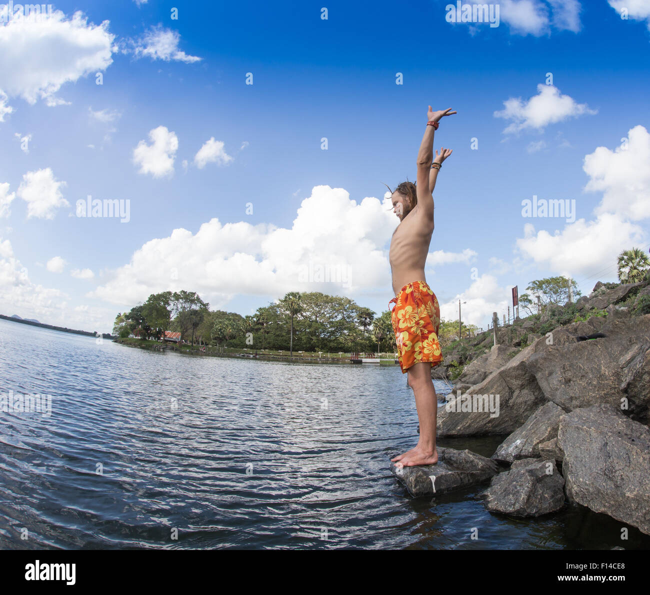 Teenage boy jumping in the river Stock Photo - Alamy