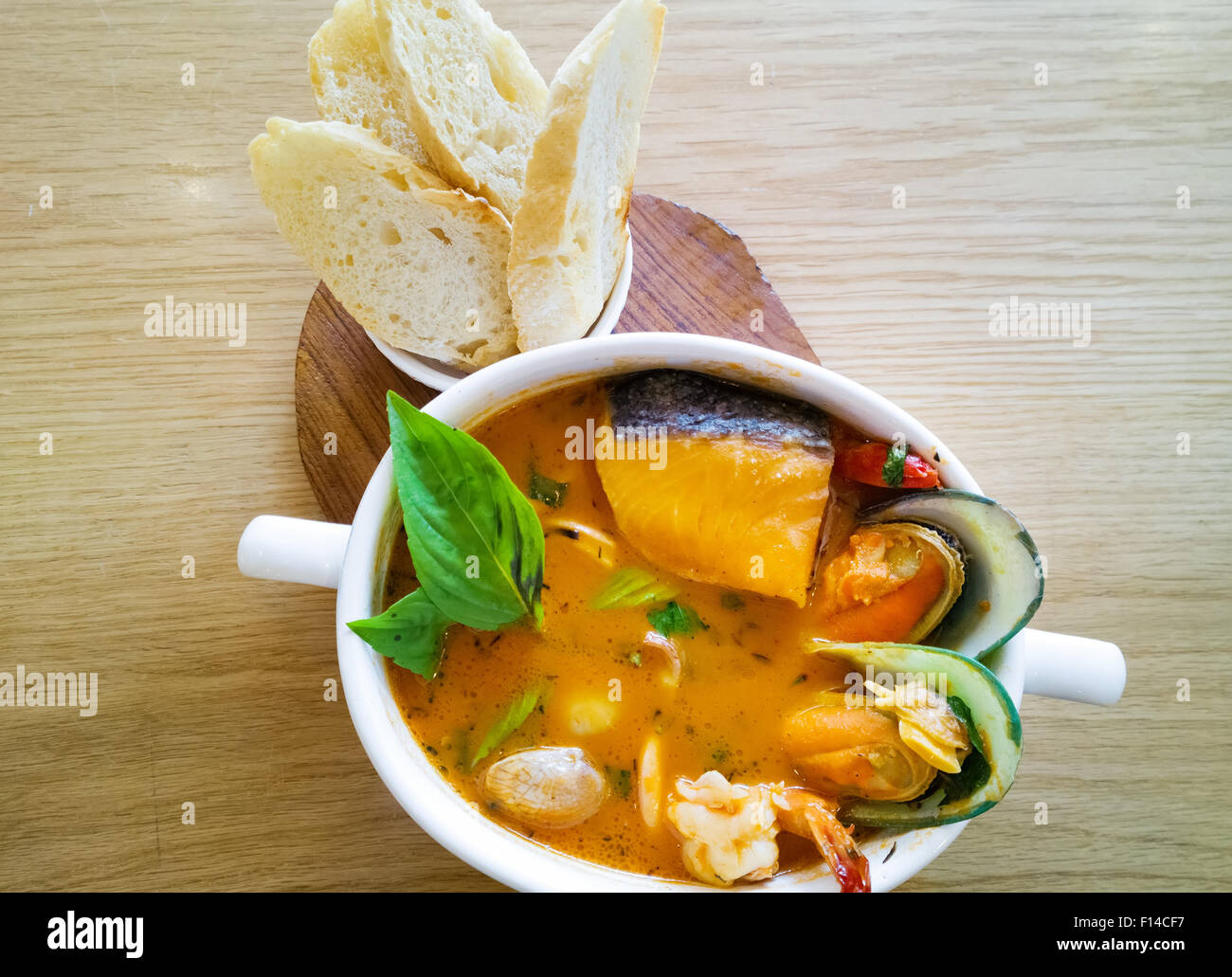Delicious mediterranean seafood soup on wooden table Stock Photo - Alamy