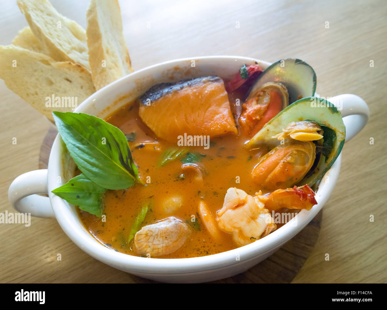Delicious mediterranean seafood soup on wooden table Stock Photo - Alamy