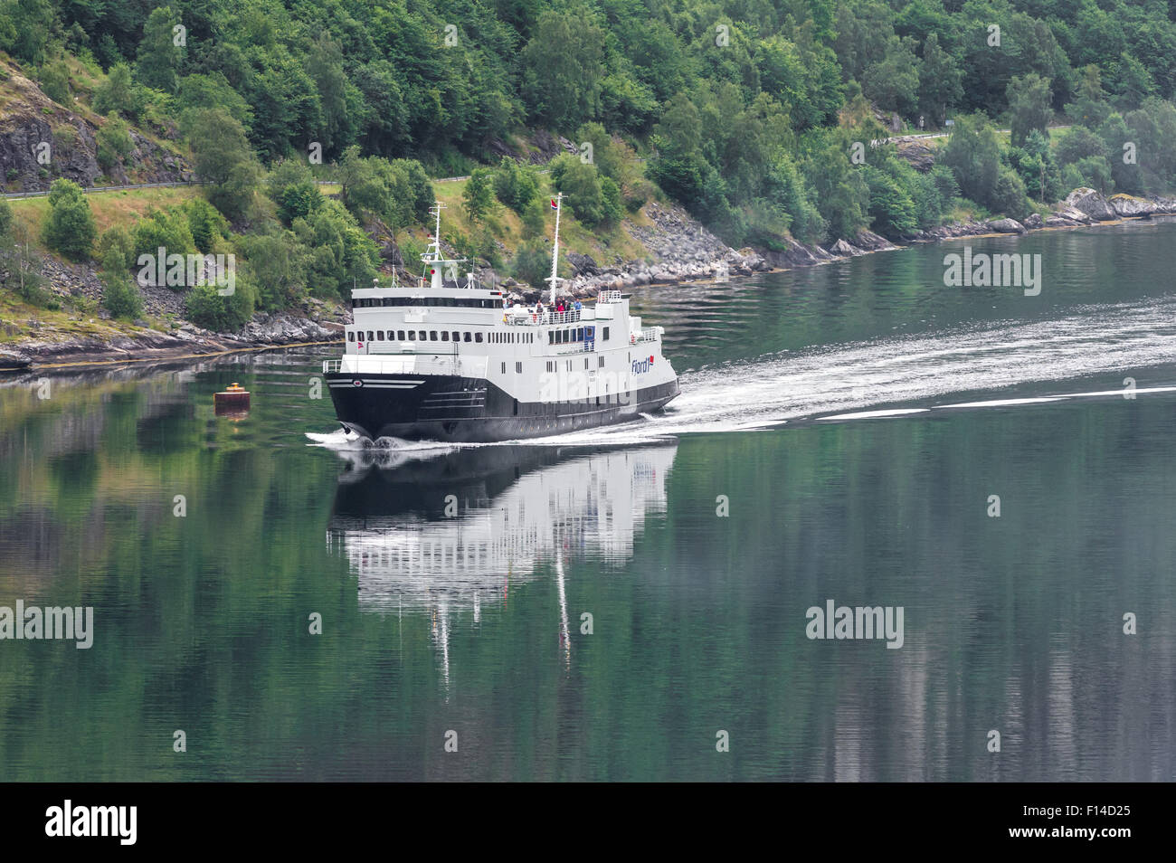 Norwegian ferry leaving the port of Geiranger in Norway down the ...