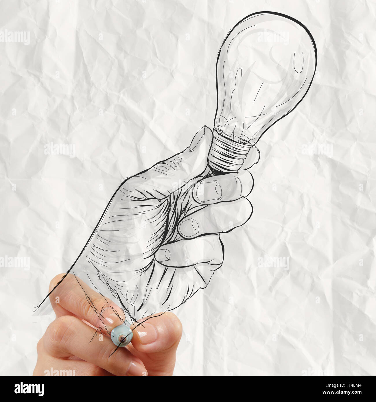 Hand drawing hand hold light bulb on crumpled paper background as ...