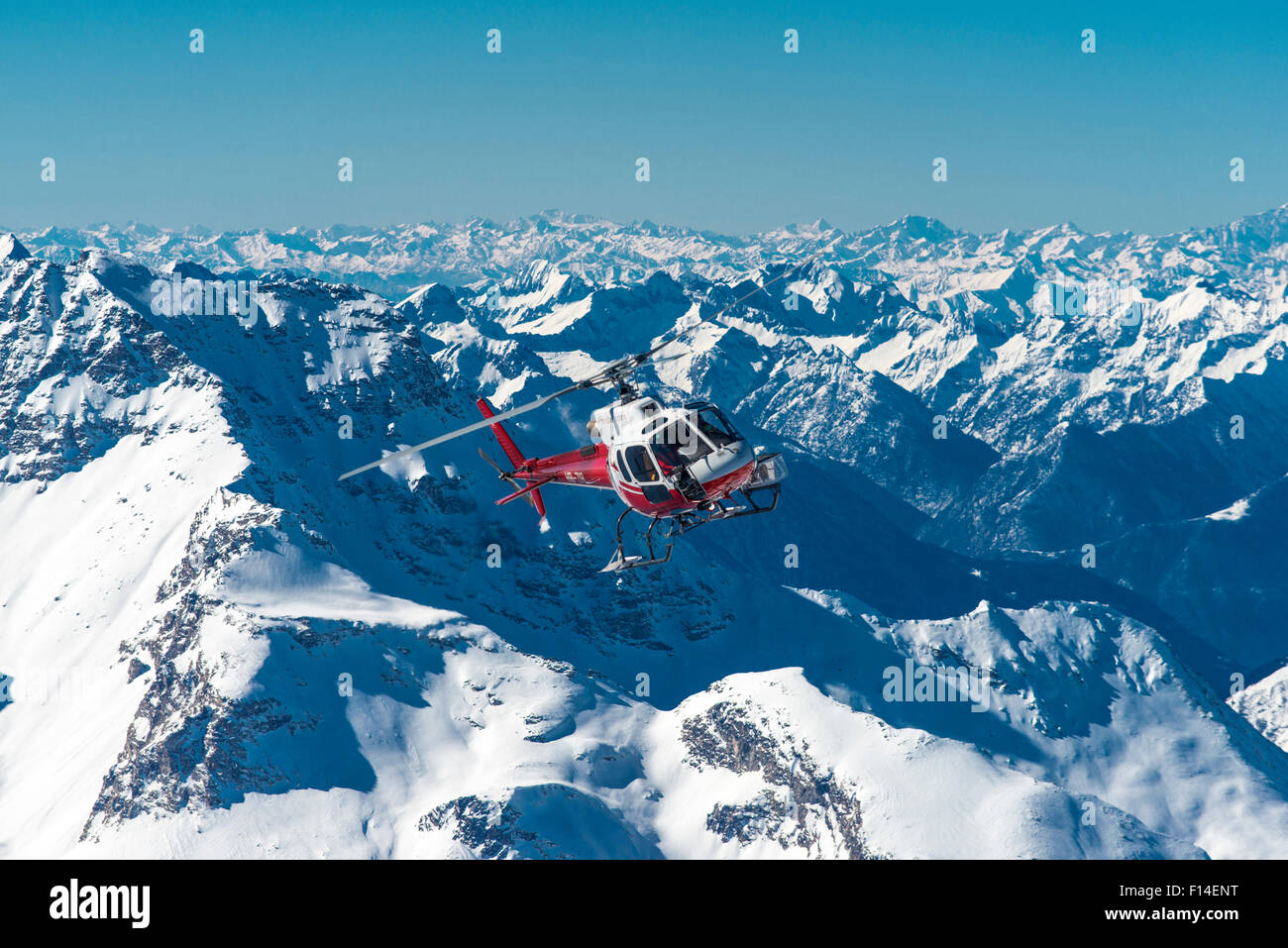 Helicopter in flight against mountains, in winter, Swiss Alps, Engadin ...
