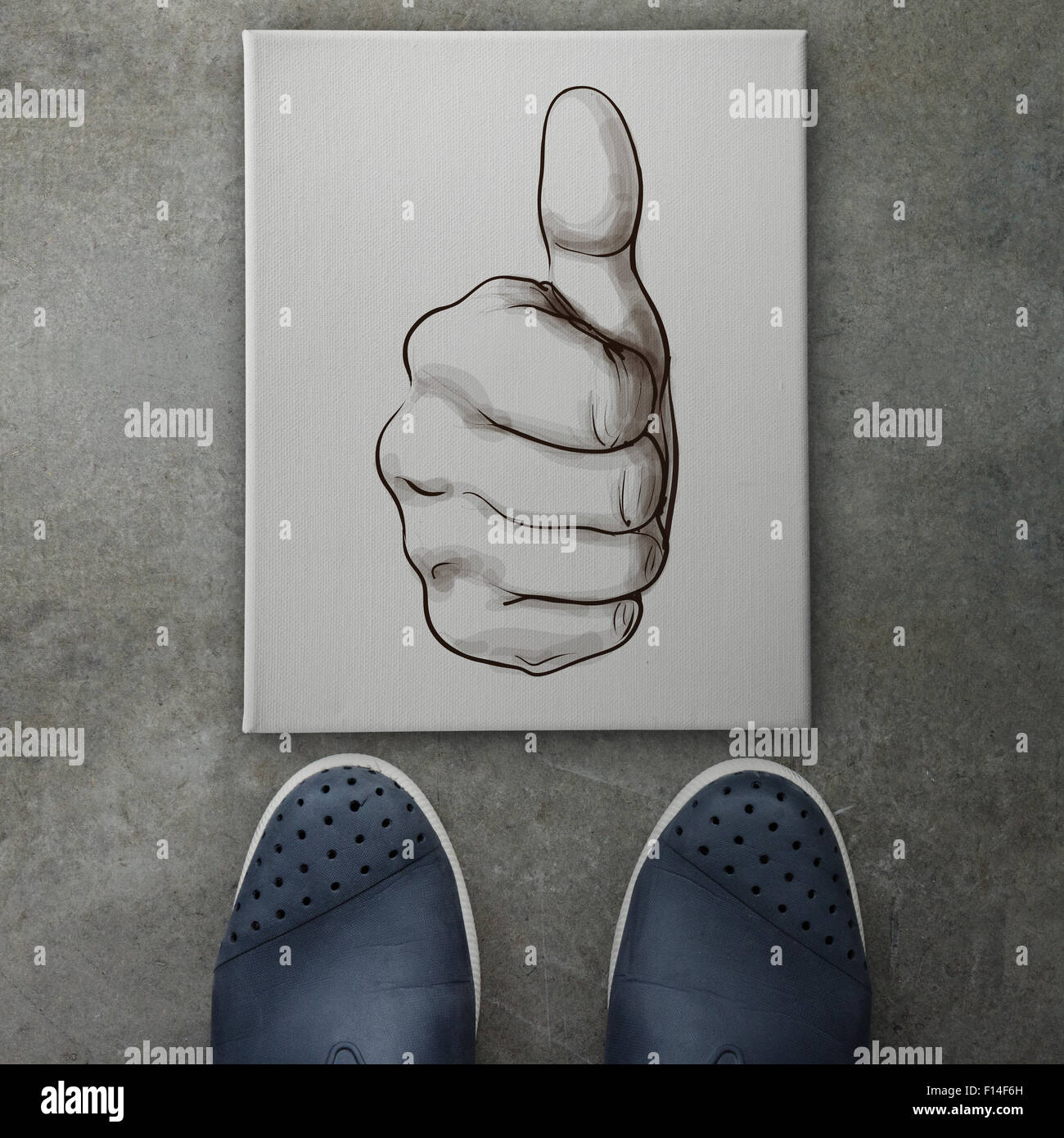 hand giving a thumbs up on front of business man feet as concept Stock ...