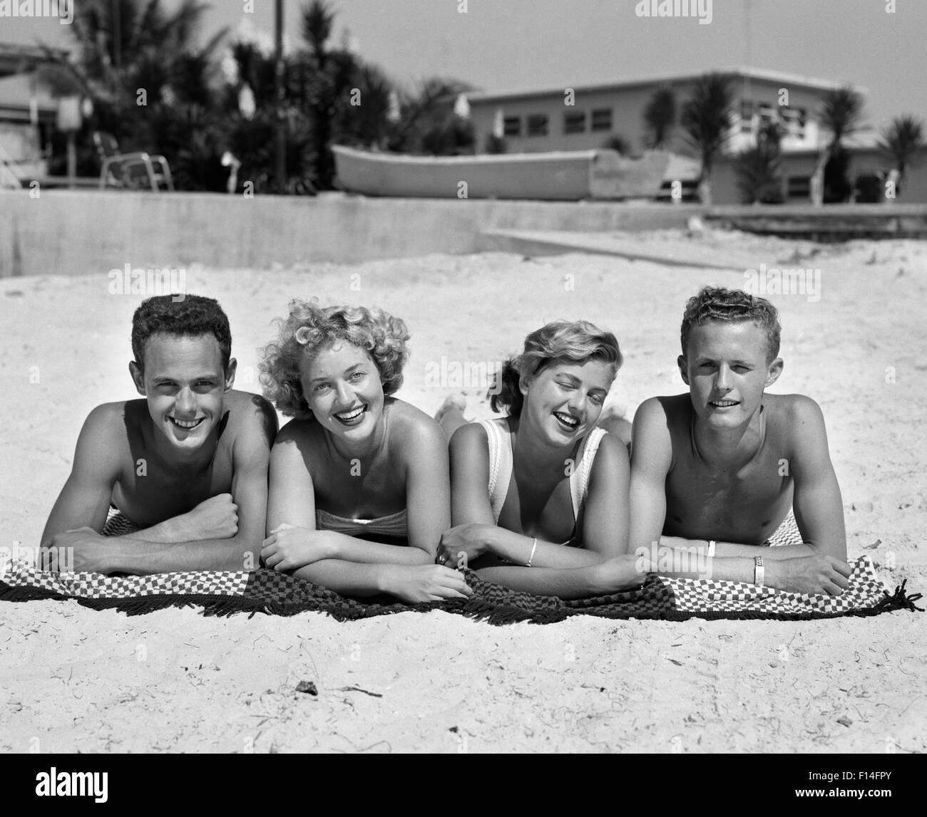 Young woman sunbathing on sand Black and White Stock Photos & Images ...