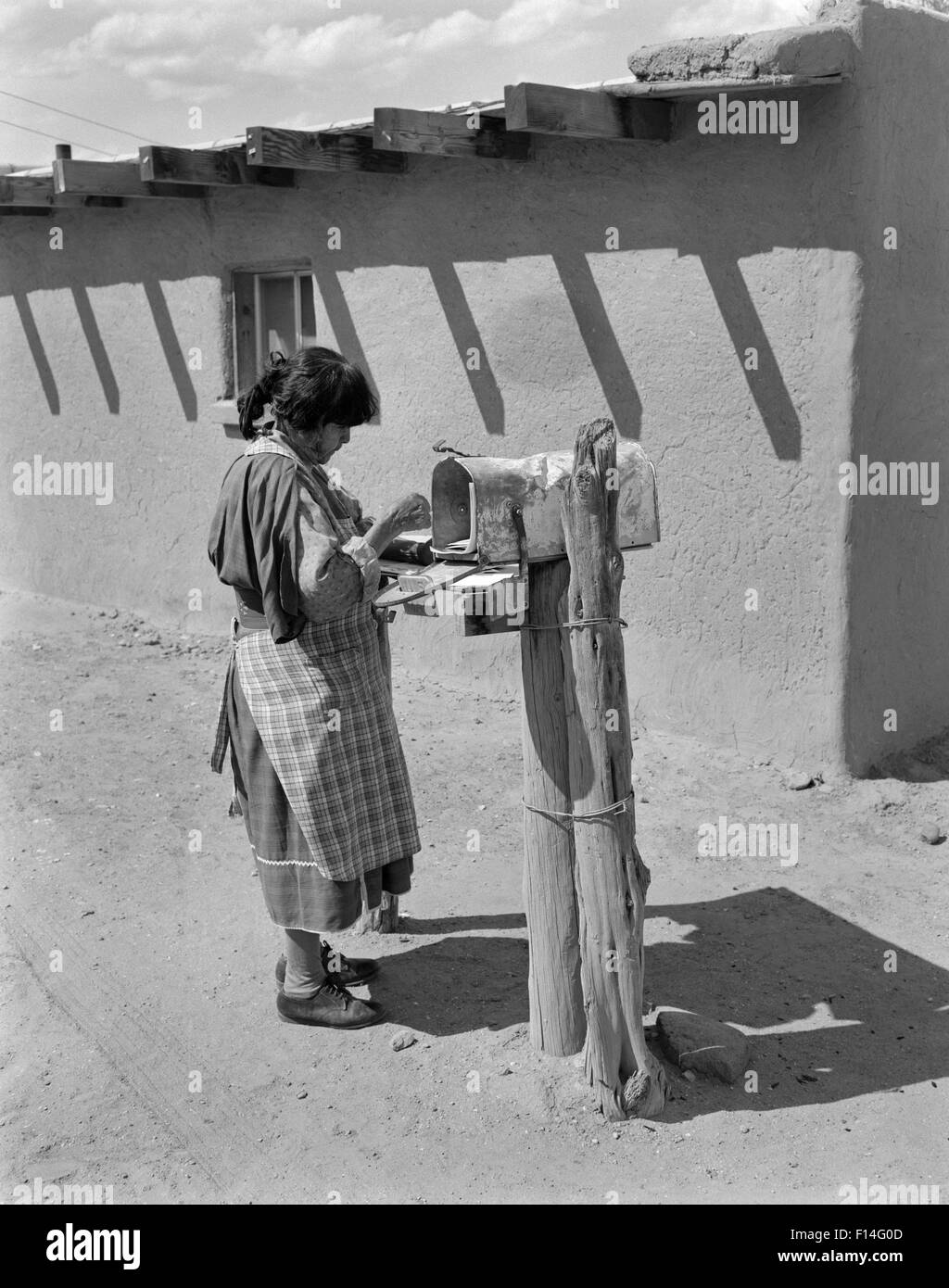 1960s NATIVE AMERICAN WOMAN GETTING MAIL FROM MAILBOX SAN ILDEFONSO ...