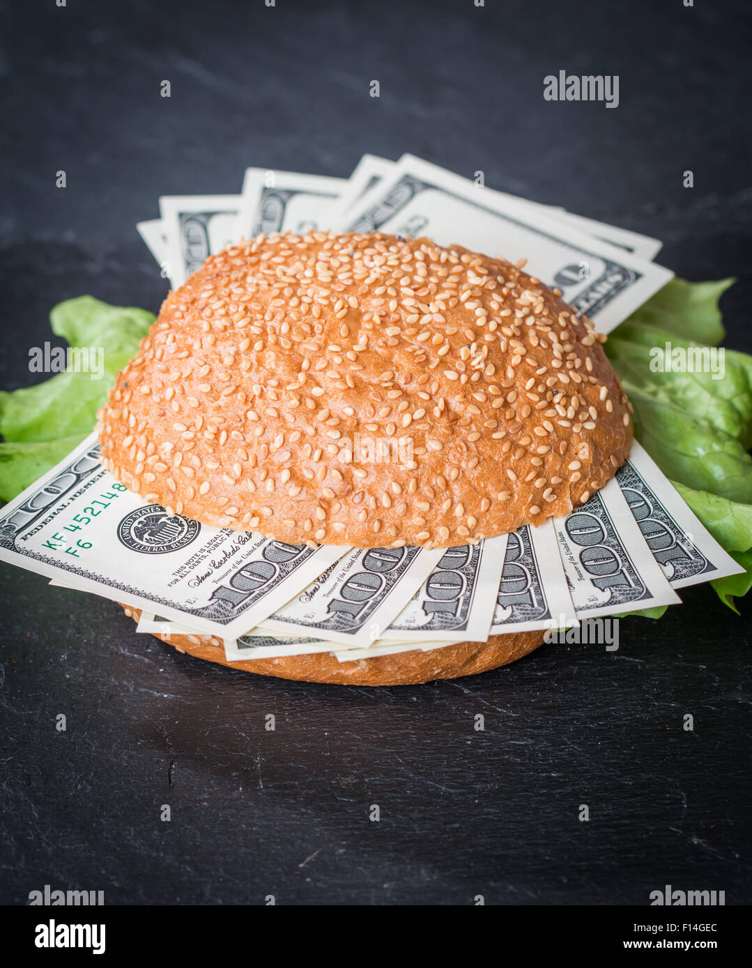 Hamburger with dollar bank notes on black background Stock Photo - Alamy