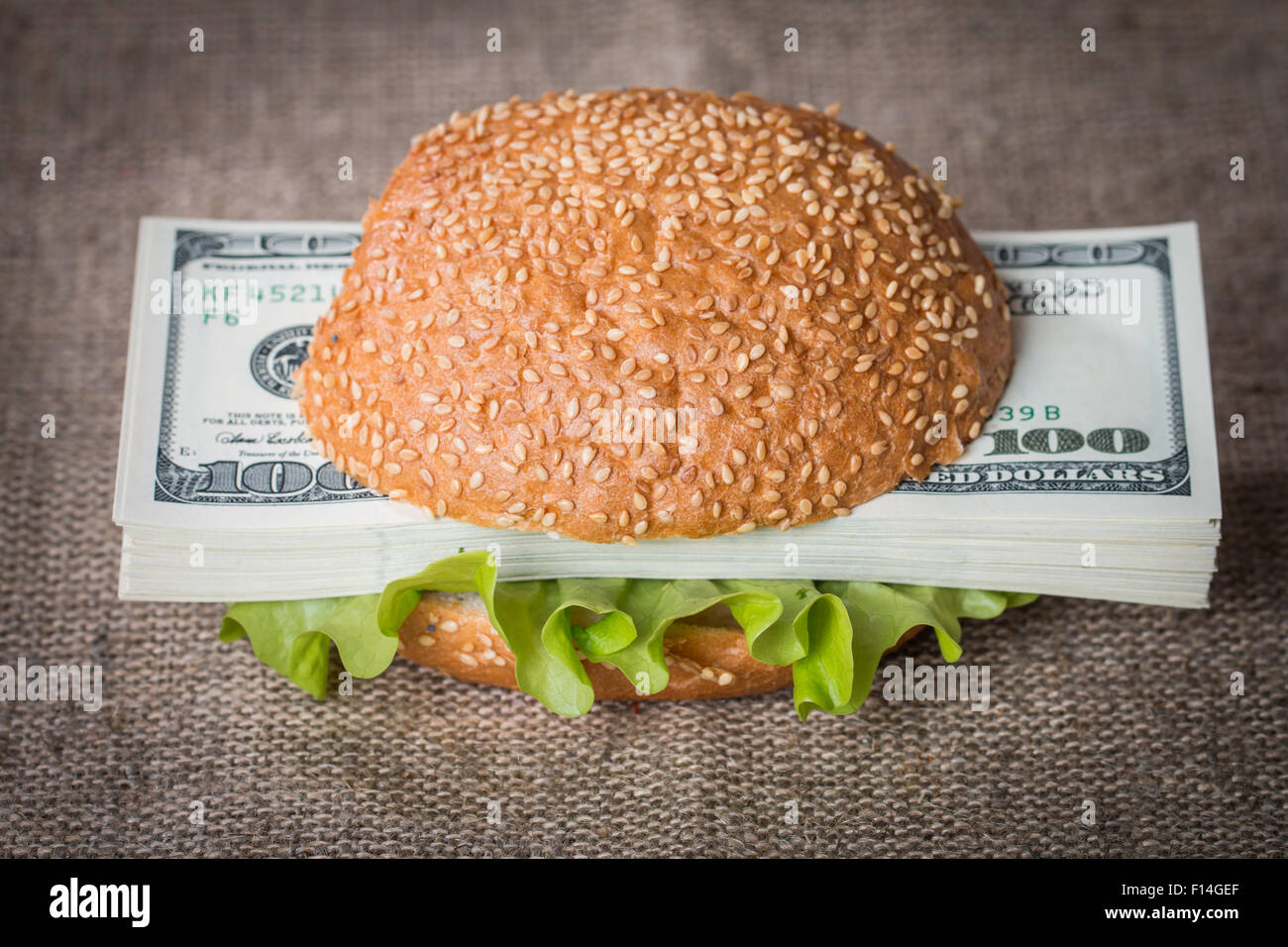 Hamburger with dollar bank notes on burpal background Stock Photo - Alamy