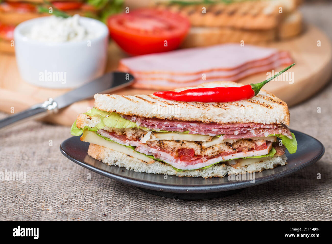 Freshly made club sandwiches served on black plate Stock Photo - Alamy