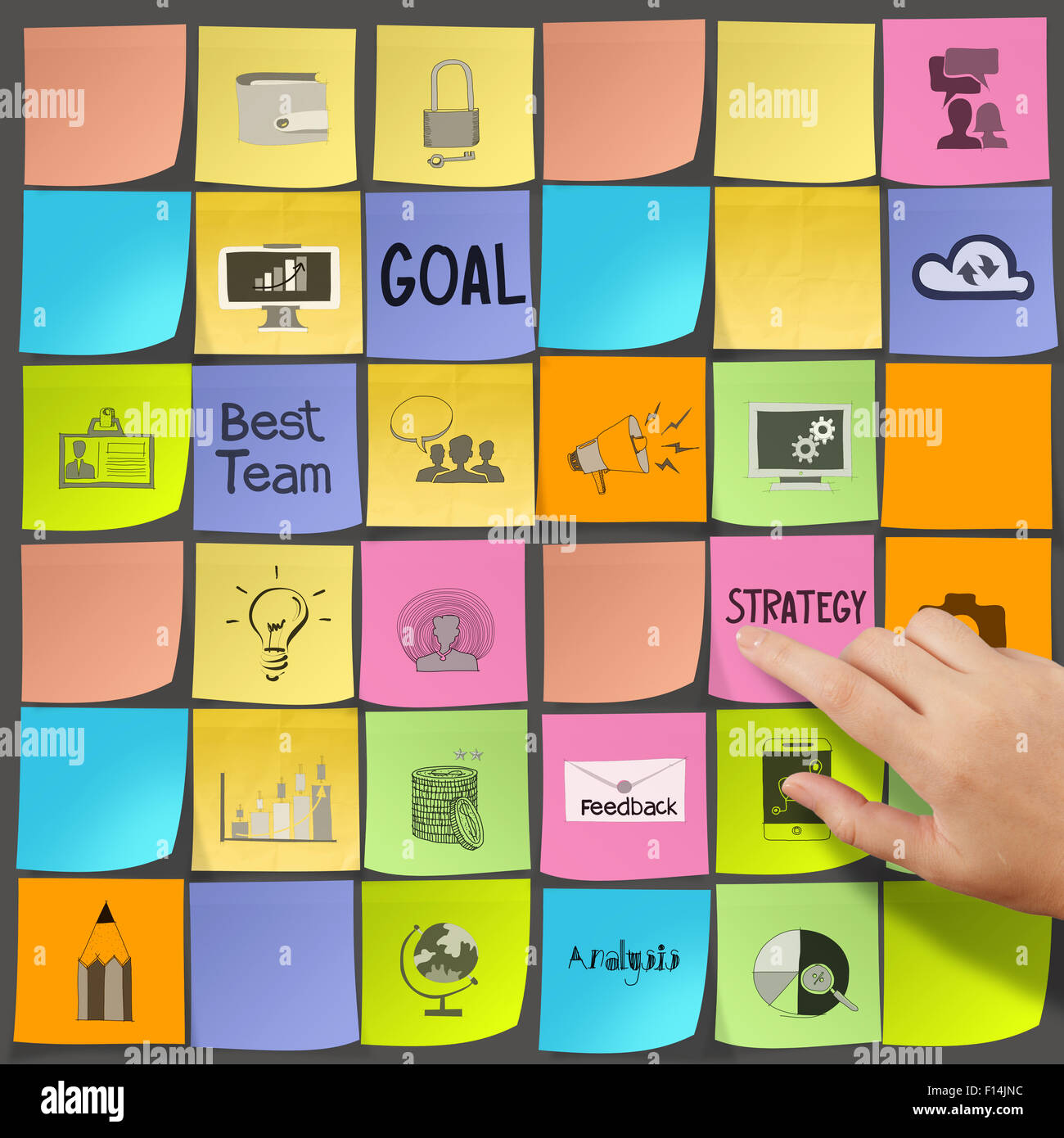 business hand push icons of business strategy on sticky note as concept ...