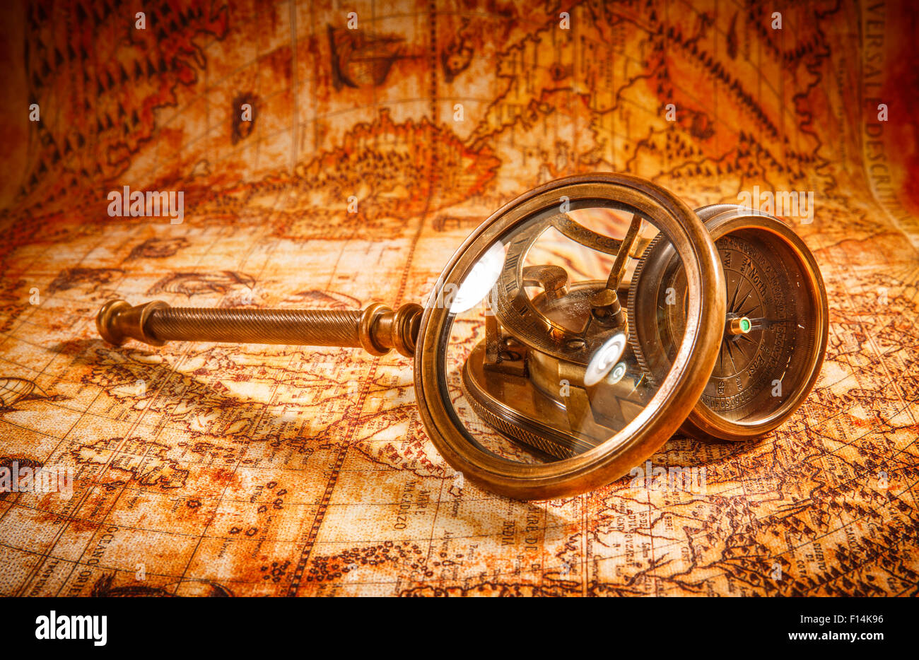 Vintage still life. Vintage magnifying glass lies on an ancient world ...