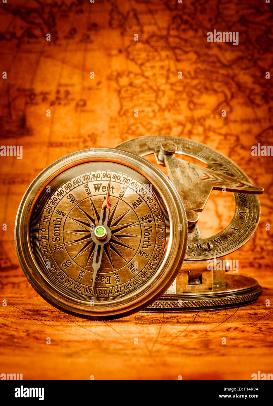 Vintage still life. Vintage compass lies on an ancient world map in ...