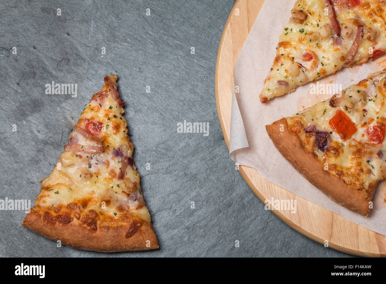 Fresh tasty pizza slices on black background, top view Stock Photo - Alamy