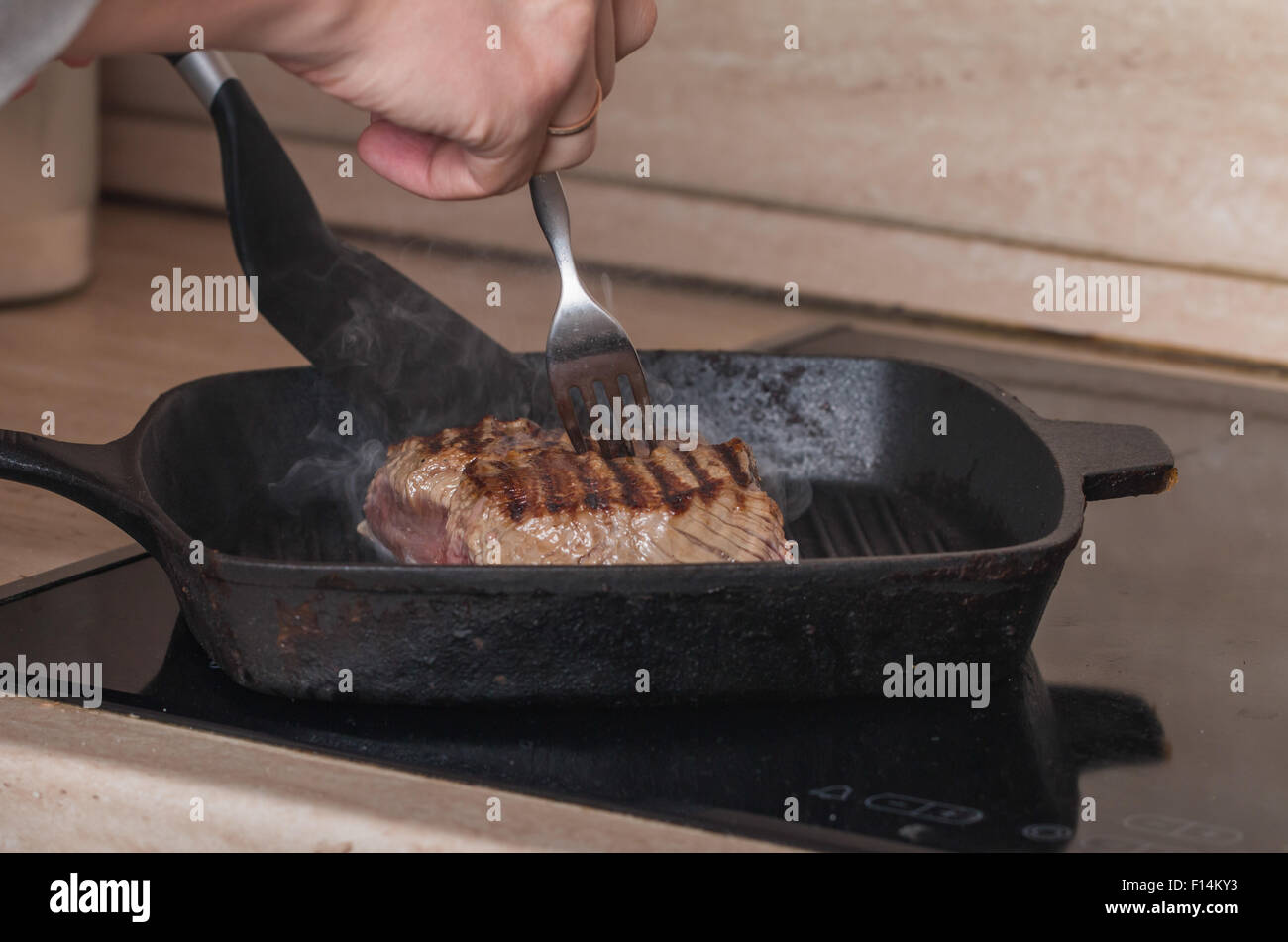 Hot Grilled beef steaks are cooking on grill pan Stock Photo - Alamy