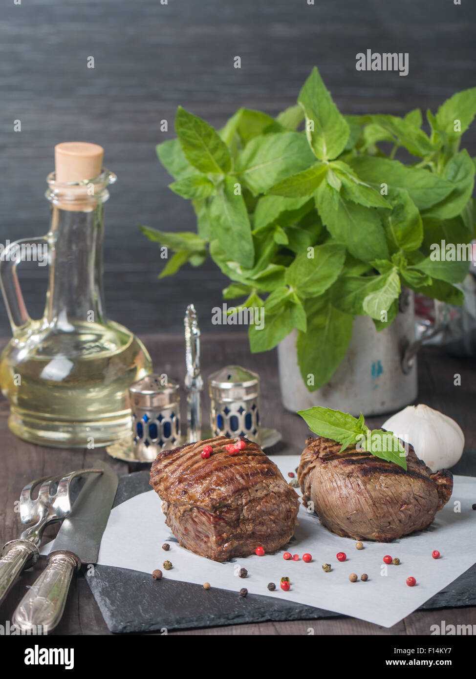 Grilled beef steak close up on paper on wooden table Stock Photo - Alamy