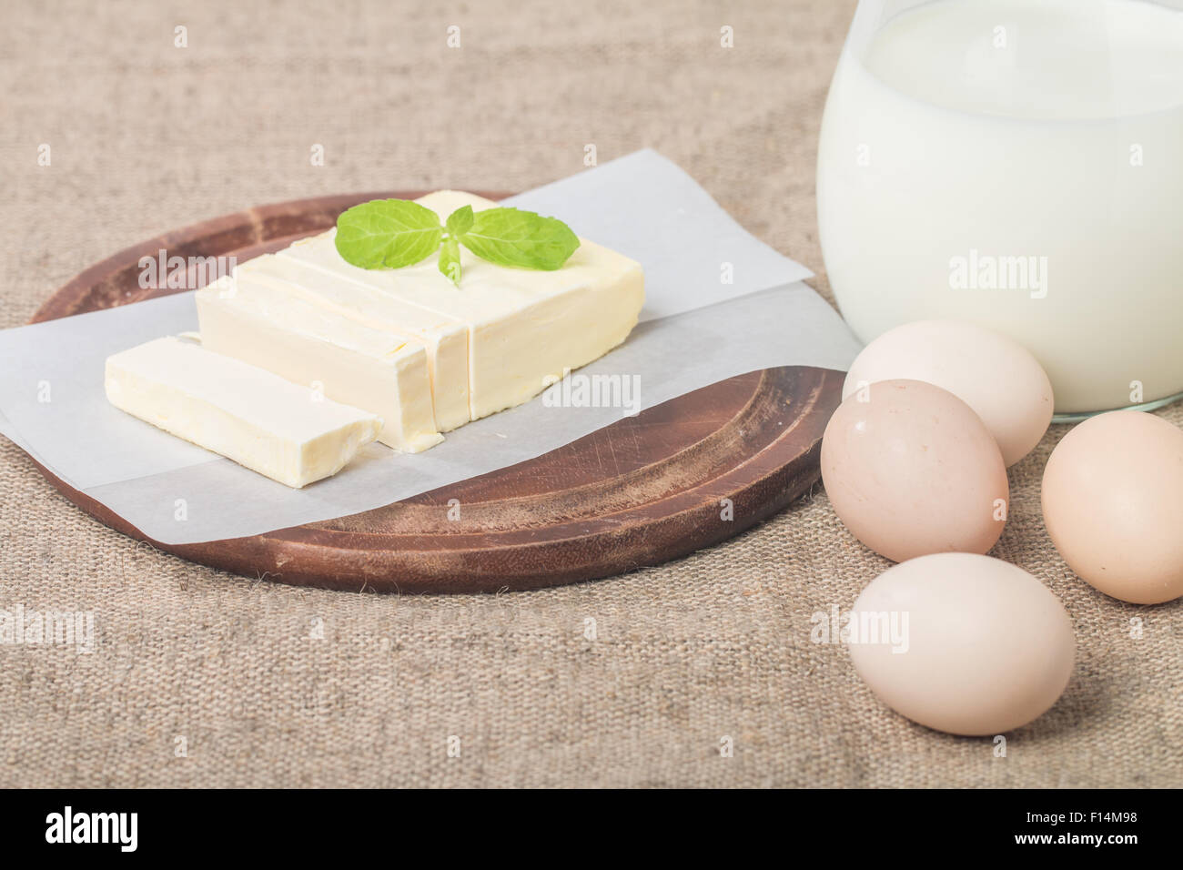 Butter on sheet of paper on burlap background Stock Photo - Alamy