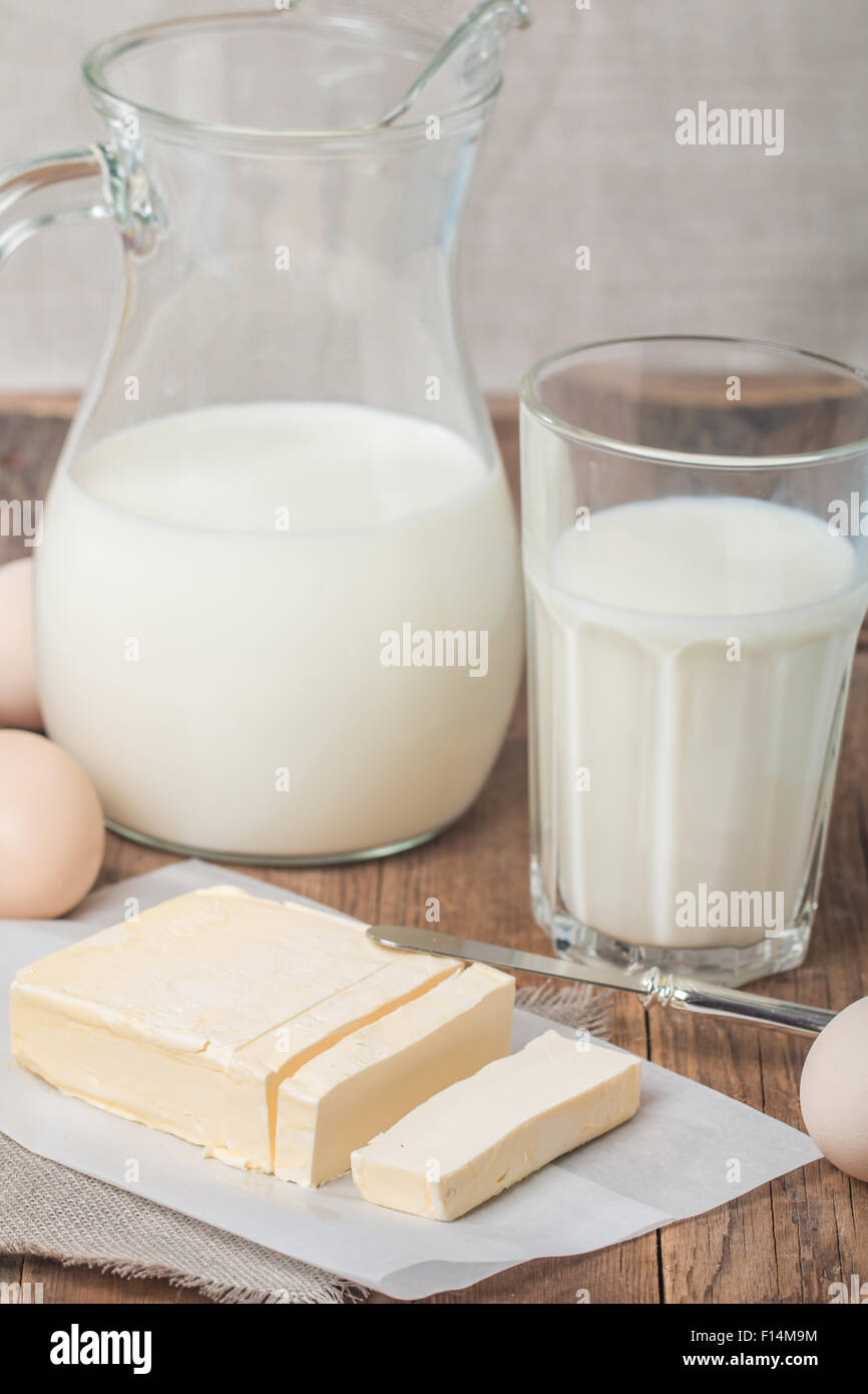 Butter on sheet of paper on wooden background Stock Photo - Alamy