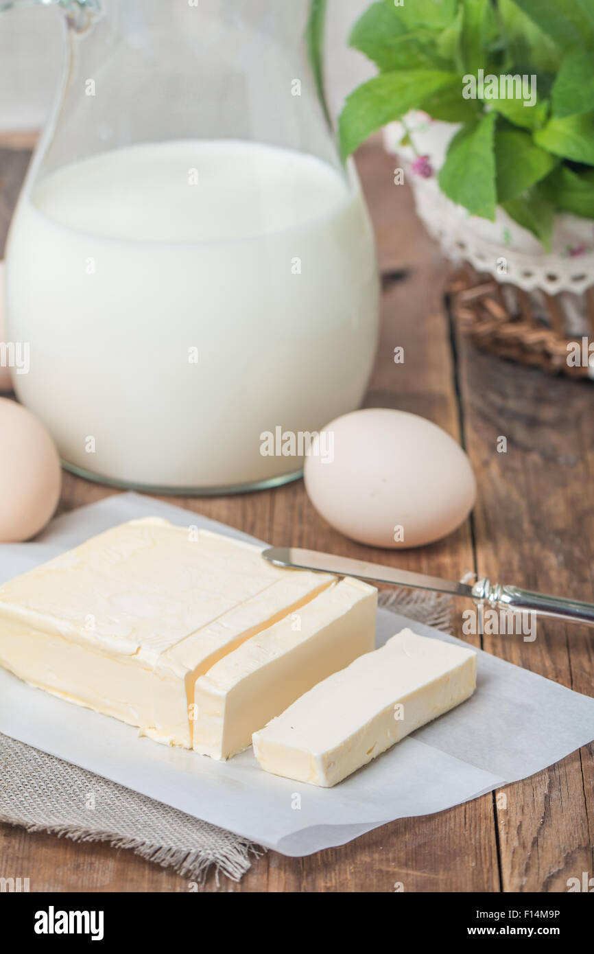 Butter on sheet of paper on wooden background Stock Photo - Alamy