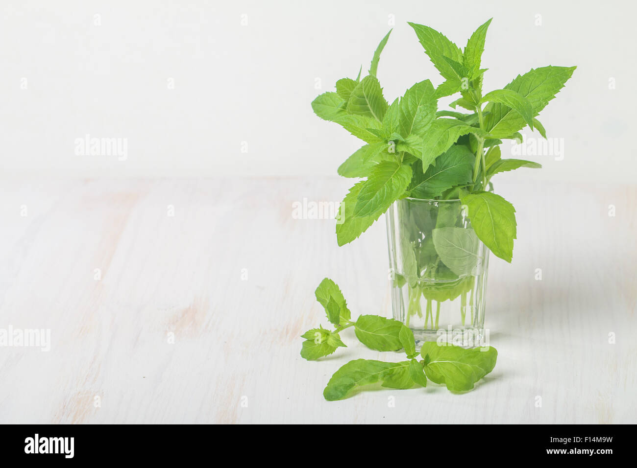Fresh mint in glass on white background Stock Photo - Alamy
