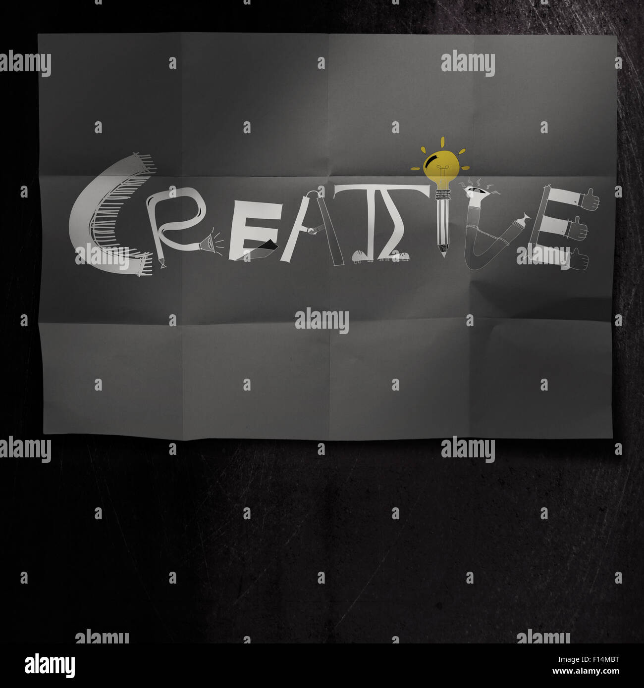 design word CREATIVE on dark crumpled paper and texture background as ...