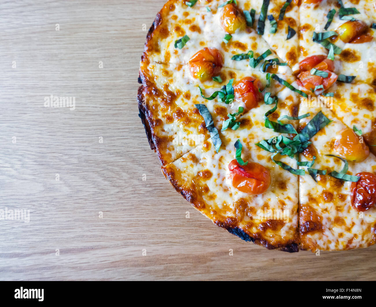 Delicious italian pizza on wood table Stock Photo - Alamy