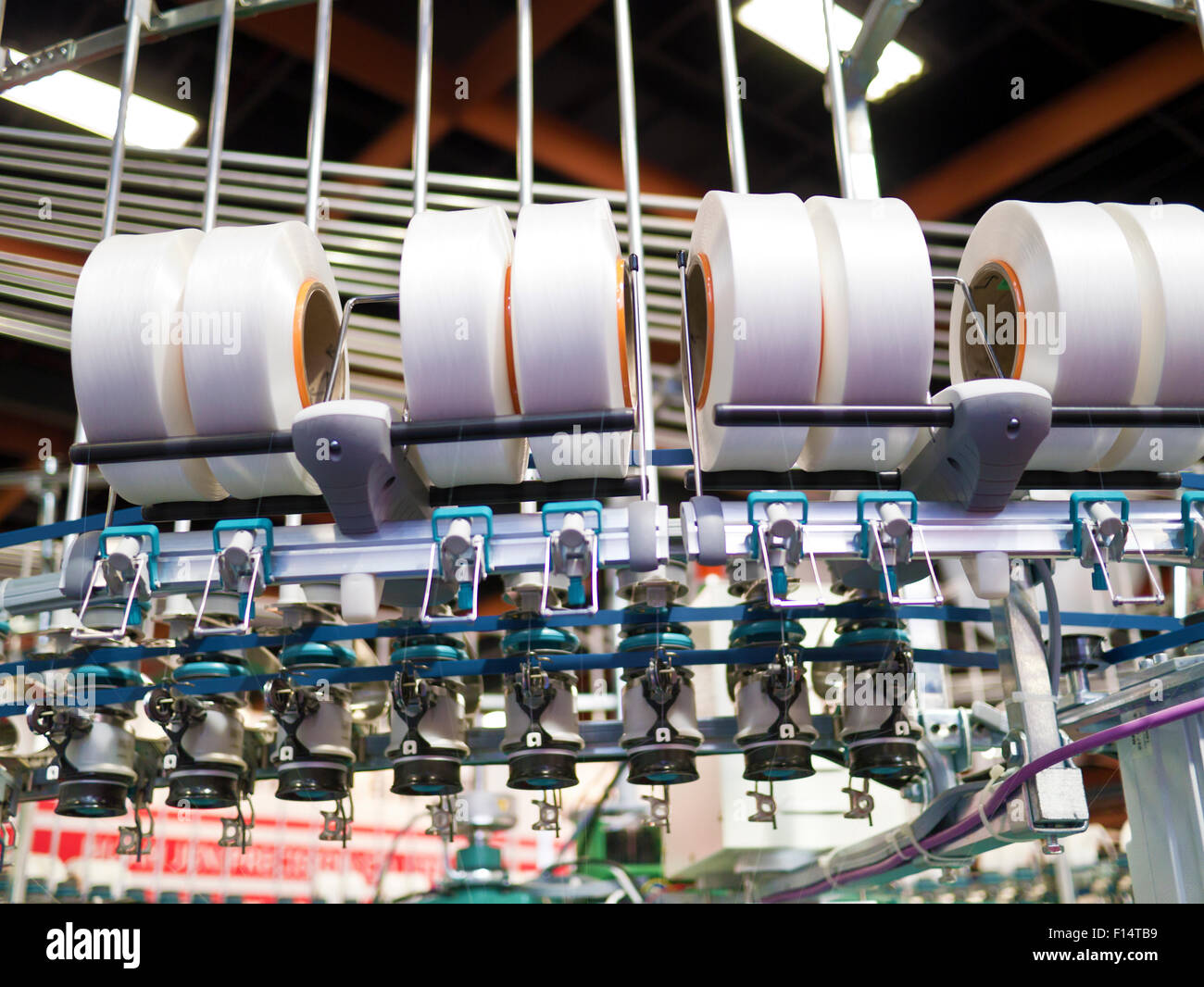 Textile industry - yarn spools on spinning machine in a textile factory ...