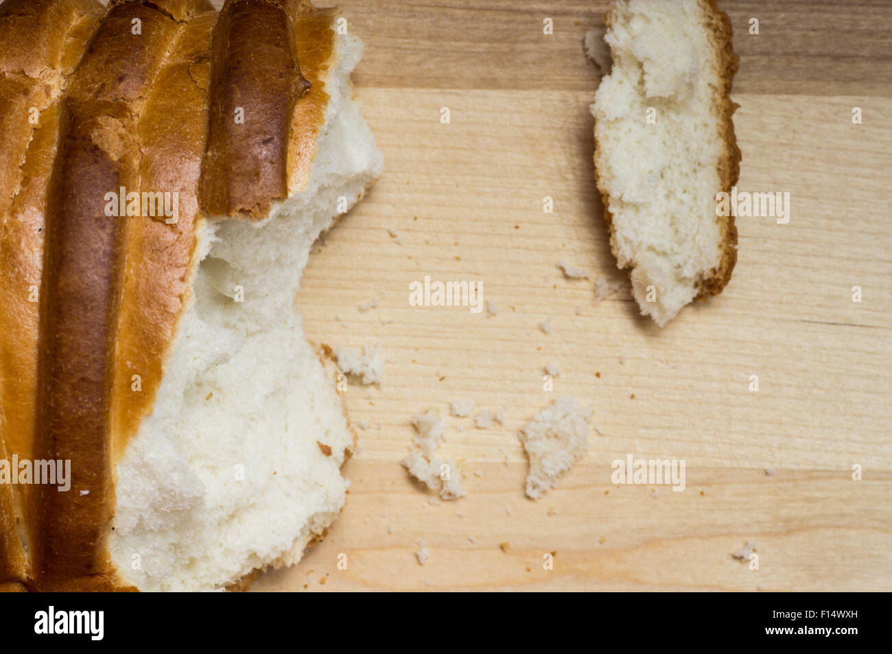 Break off a piece of loaf with crumbs on the table Stock Photo - Alamy