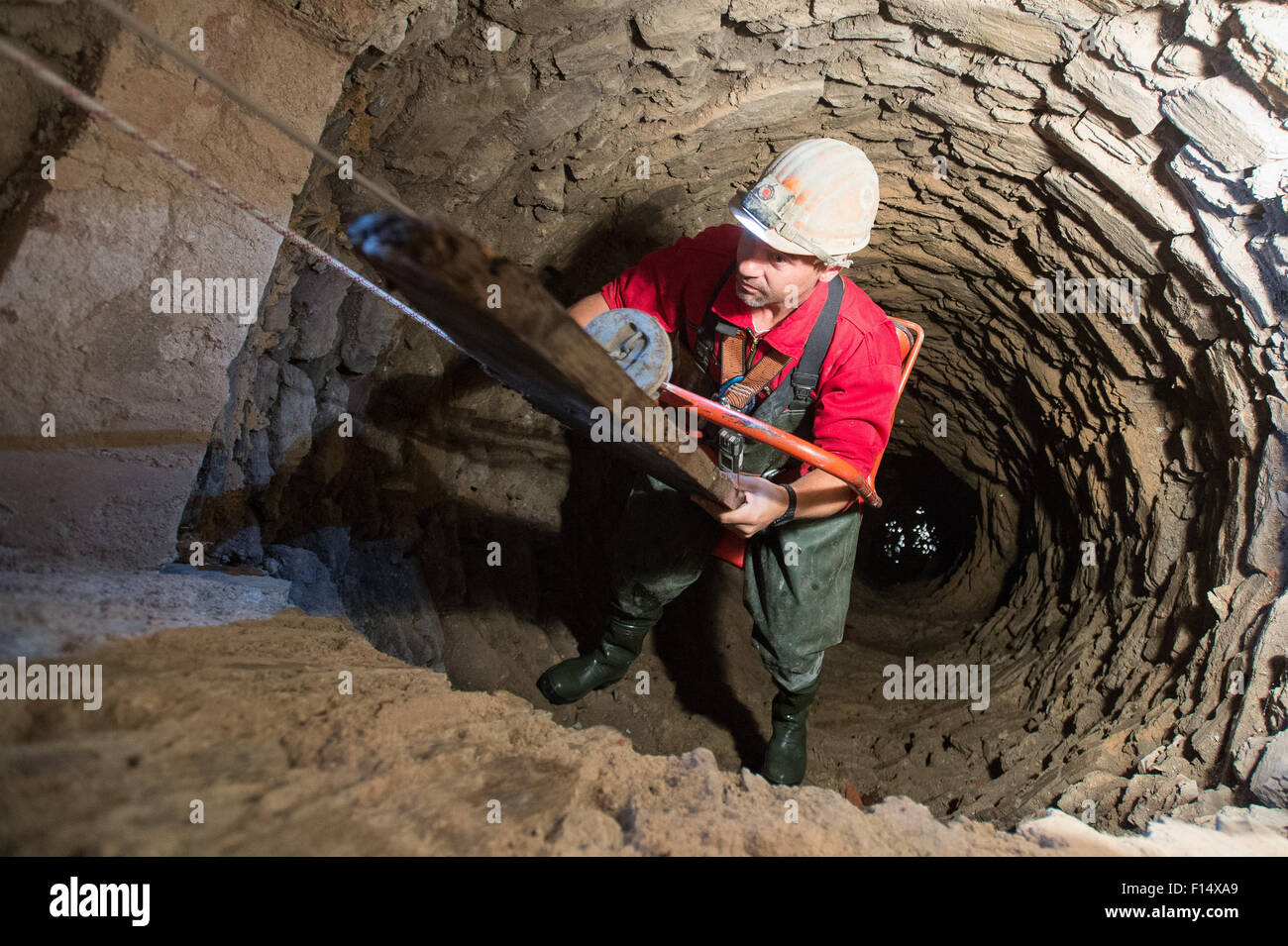 A piece of wood from a 20 metre deep shaft passes through the hands of ...