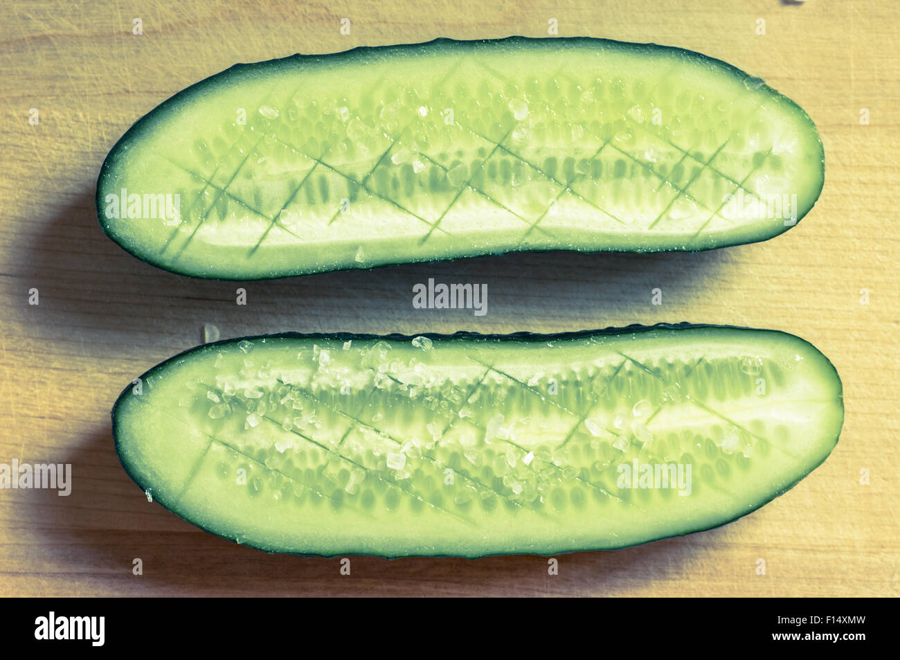 Halved cucumber with salt top view Stock Photo - Alamy
