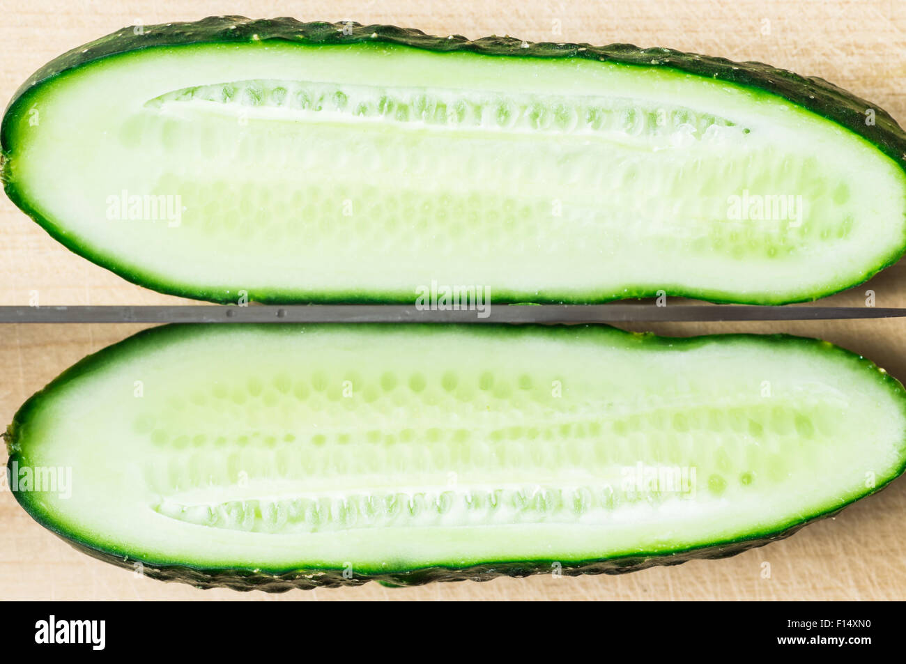Cut the cucumber slice along the knife top view Stock Photo - Alamy
