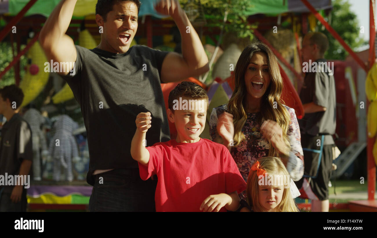 Happy cheering family winning amusement park fun fair game Stock Photo ...