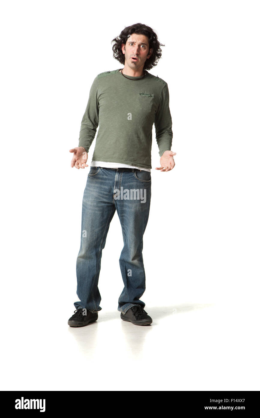 Man standing in studio with questioning gesture Stock Photo - Alamy