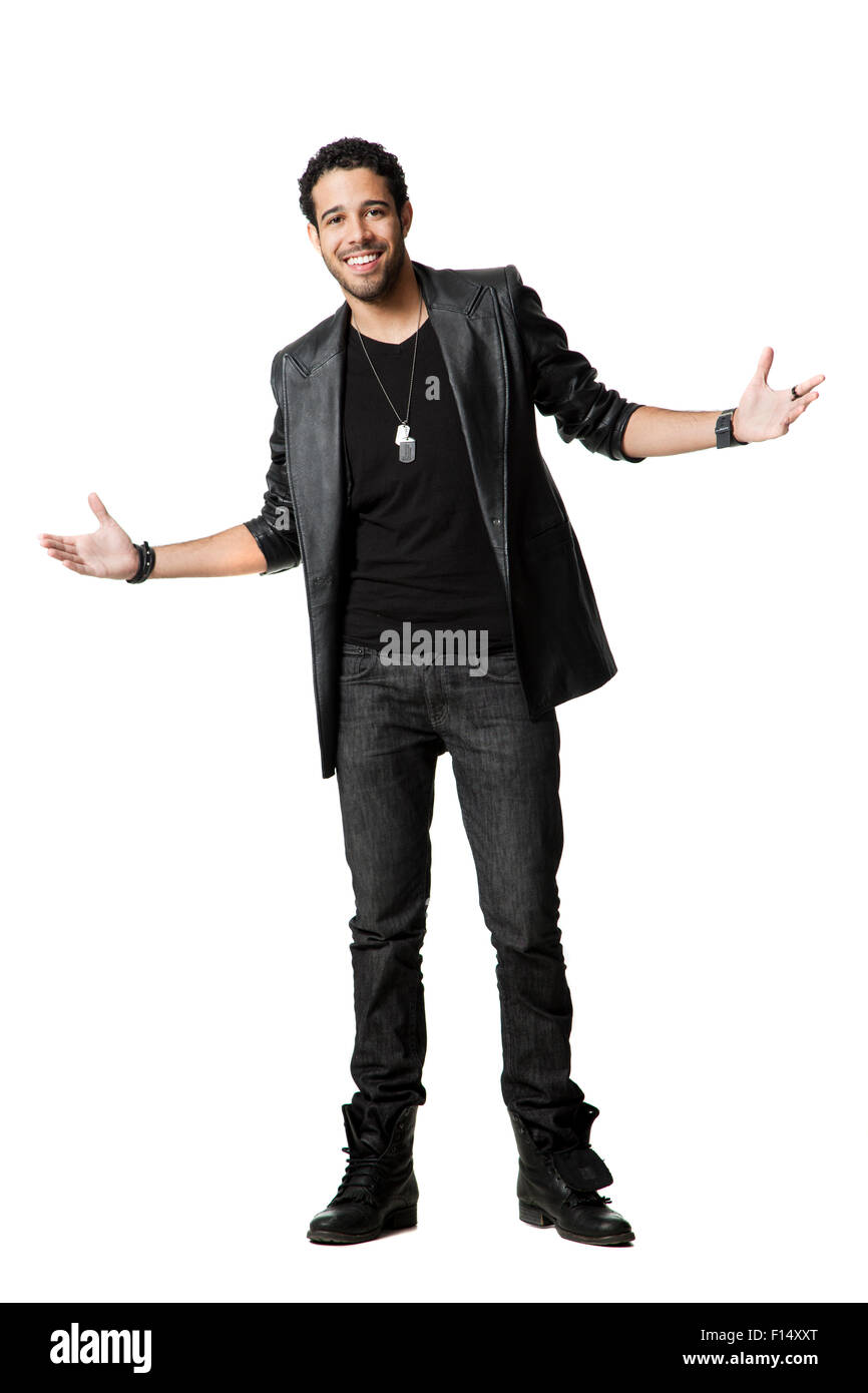 Man standing in studio with arms outstretched Stock Photo - Alamy