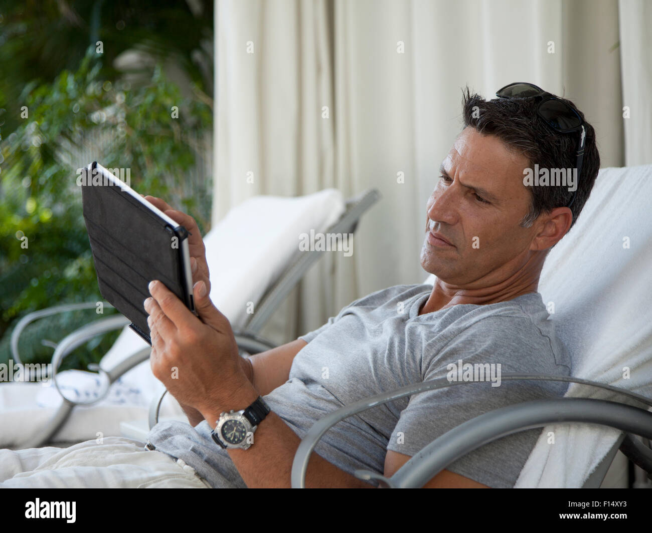 Man laying on lounge chair hi-res stock photography and images - Alamy