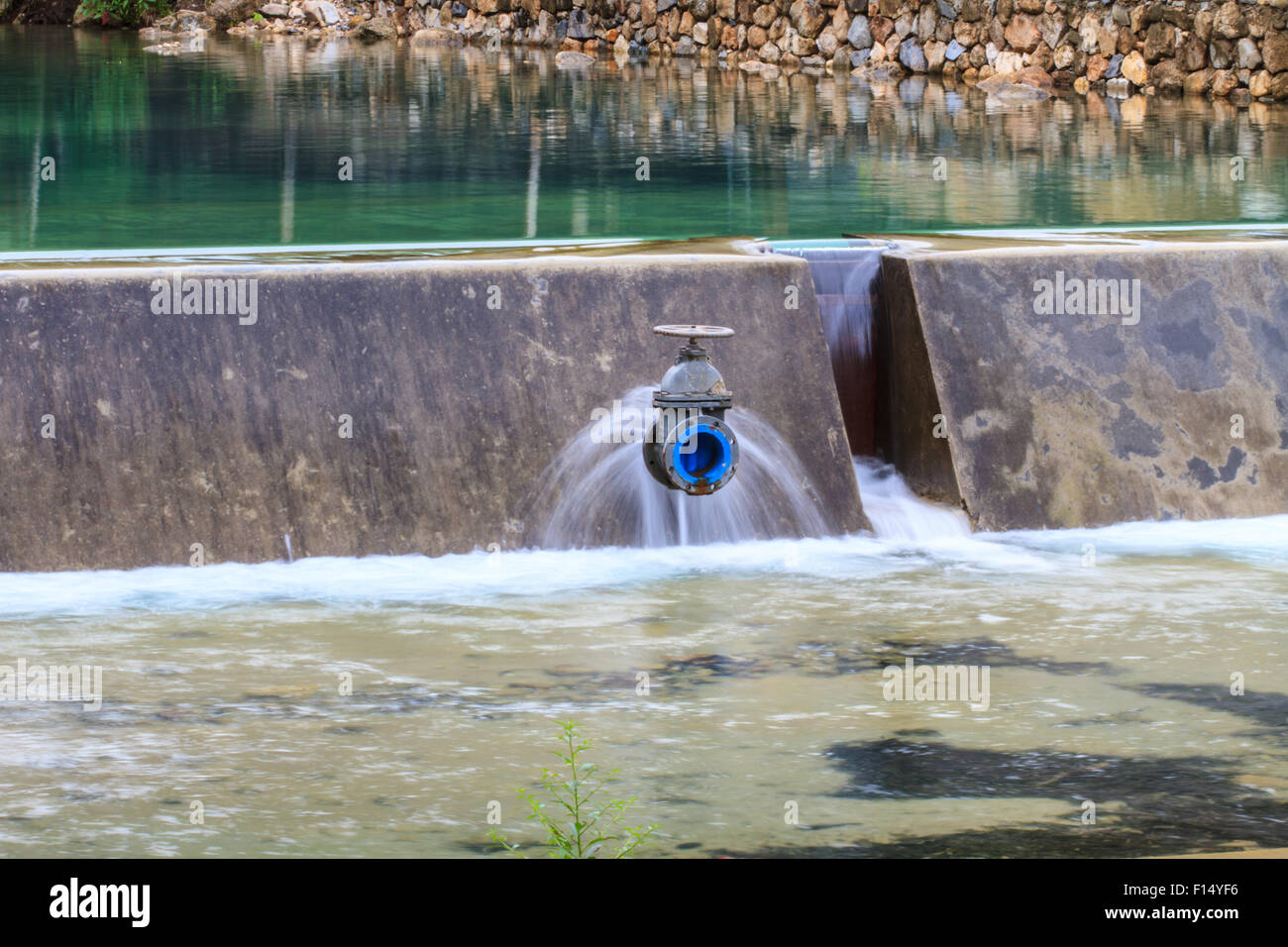 flowing water released from the open sluice gates of a dam Stock Photo ...