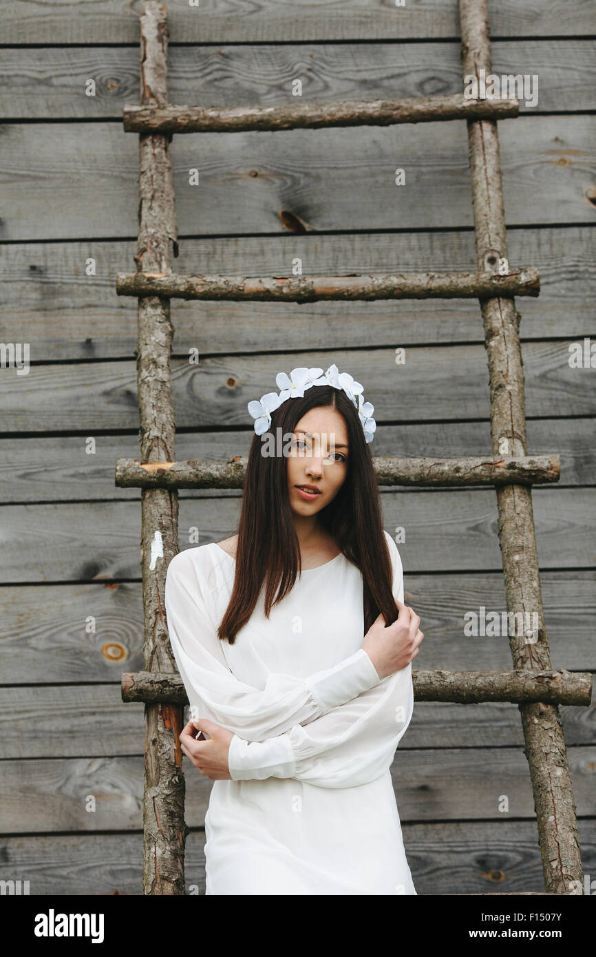 Girl climbing ladder into tree house Stock Photo - Alamy
