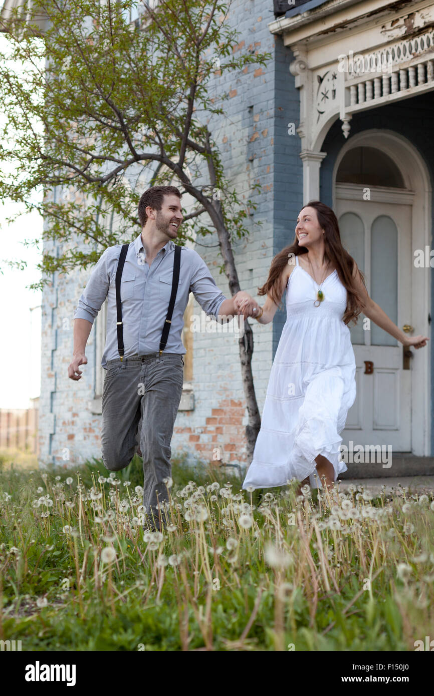 Couple young walking grass front hi-res stock photography and images ...