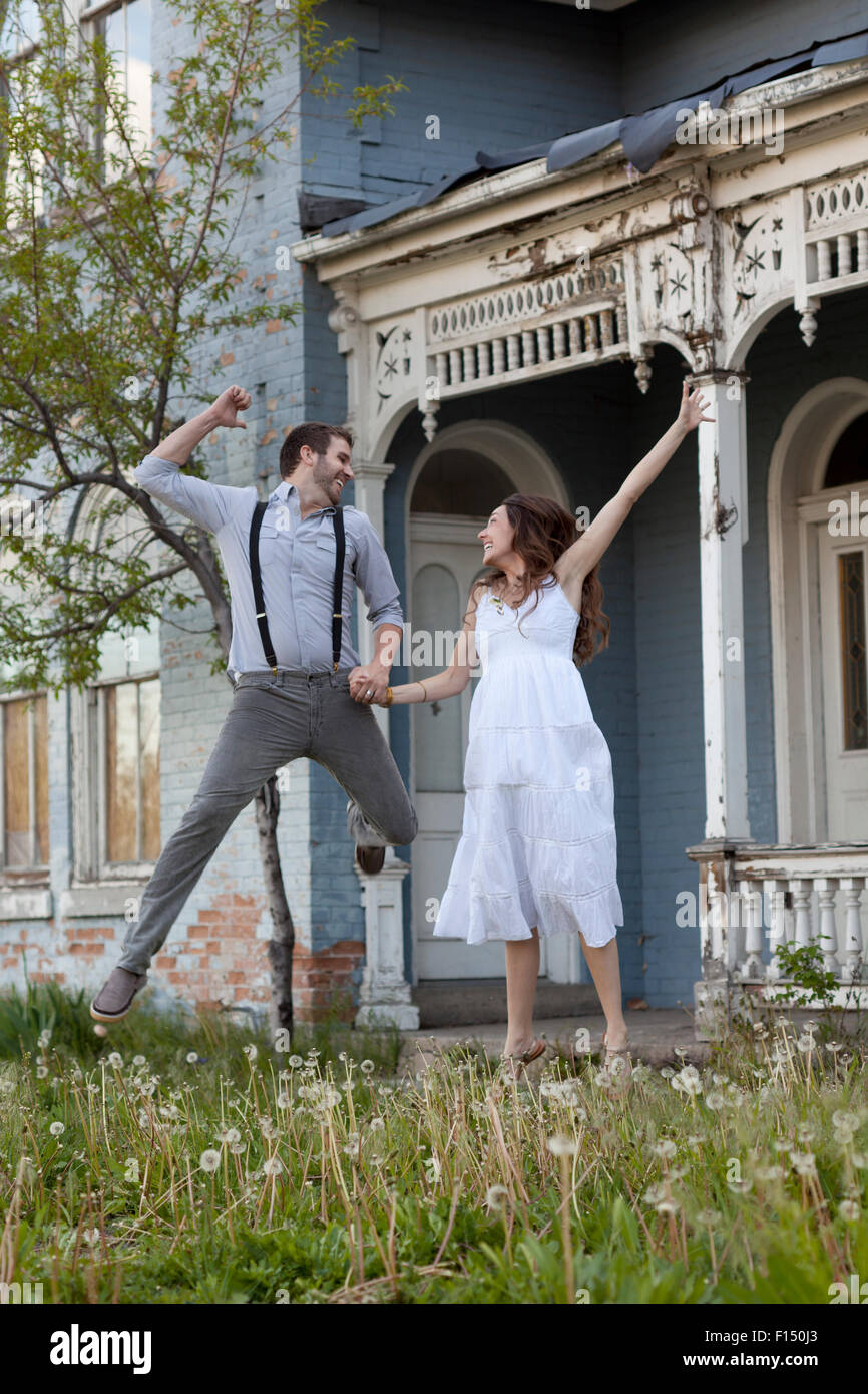 USA, Utah, Provo, Enthusiastic couple jumping in front house Stock ...