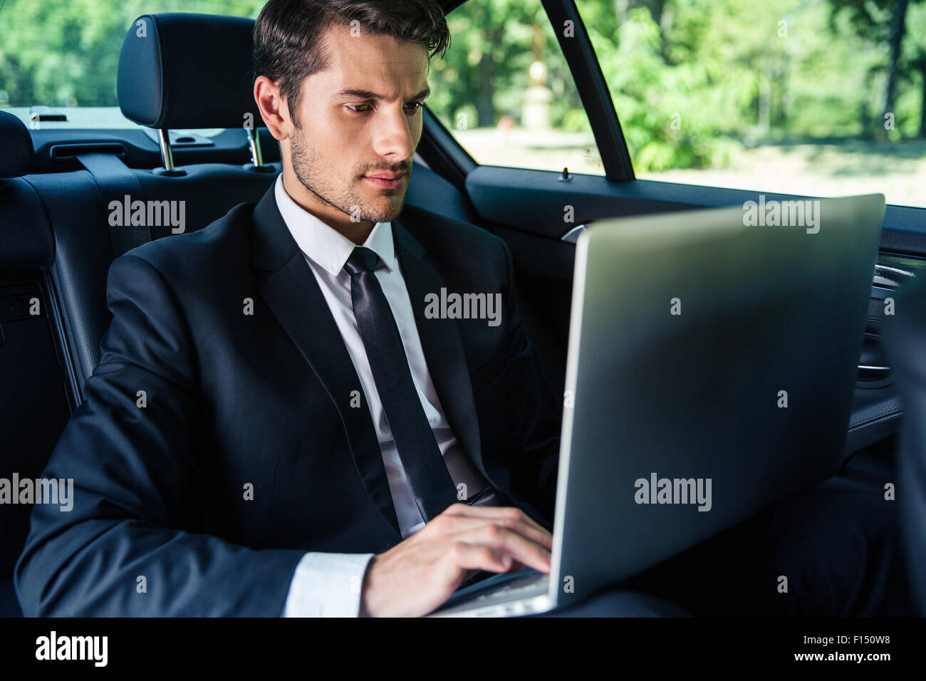 Man working in car typing hi-res stock photography and images - Alamy