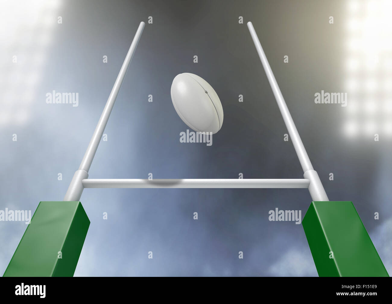 A closeup of rugby ball flying between rugby posts in a stadium under ...