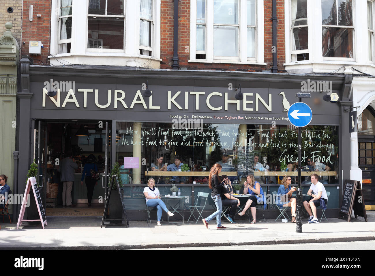People enjoying a bite to eat on the pavement at Natural Kitchen cafe ...