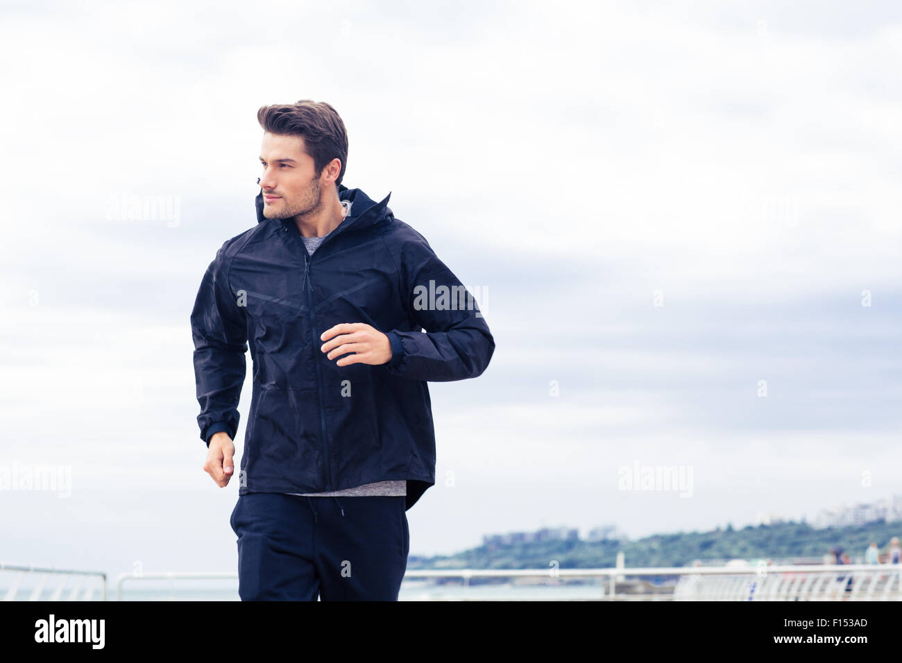 Man running into waves hi-res stock photography and images - Alamy