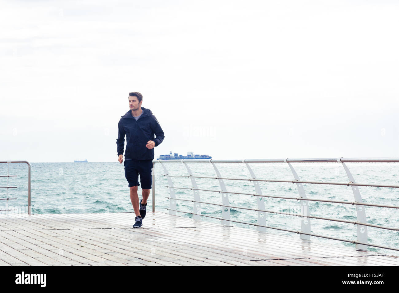 Man running into waves alone hi-res stock photography and images - Alamy