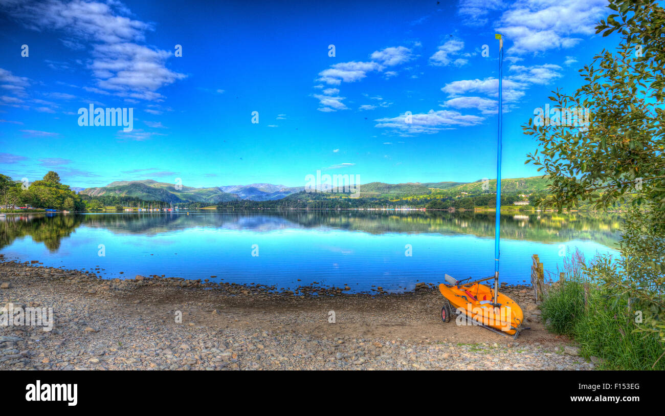 Early summer morning at beautiful lake with sailing boat on a relaxed ...