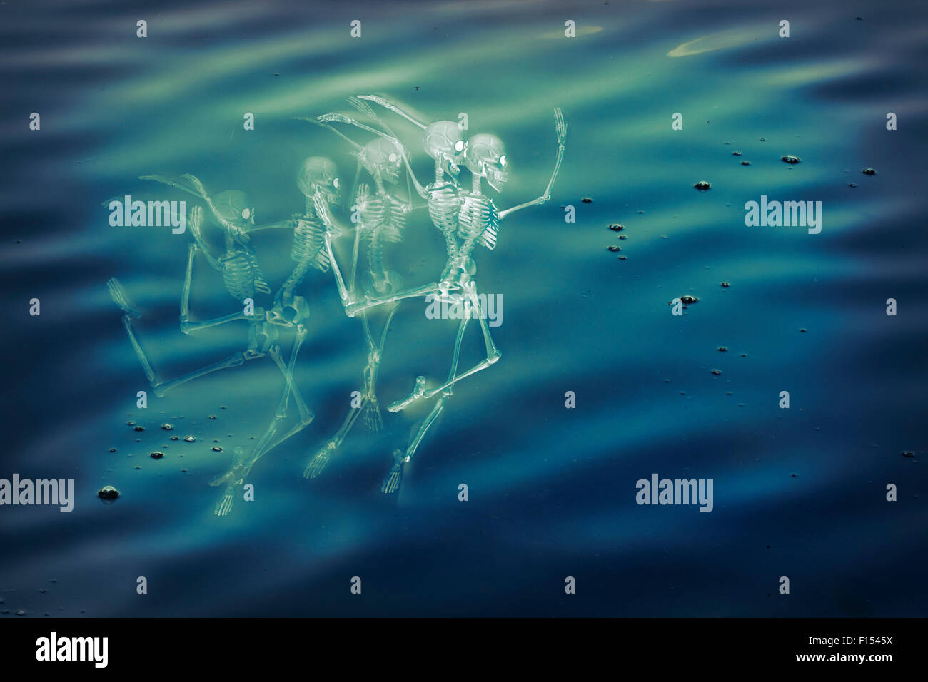 Scary dancing fairy skeletons on water background Stock Photo - Alamy