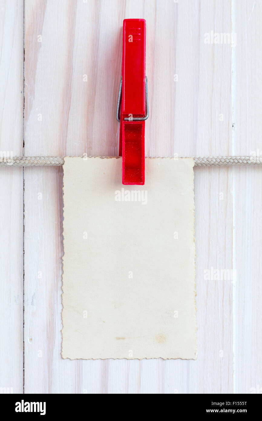 Photo frame hanging on a rope over white wooden background Stock Photo ...