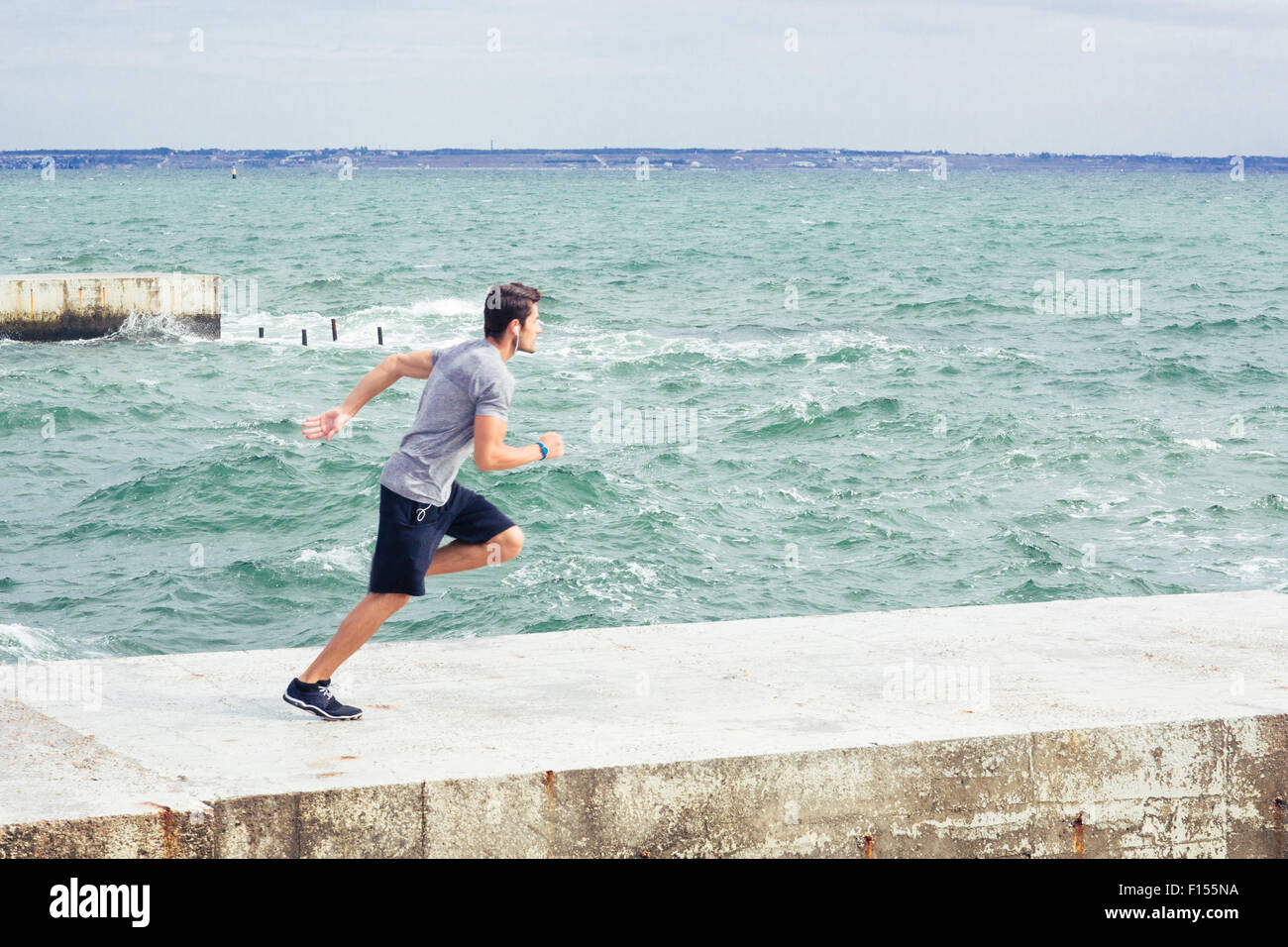 Portrait of a sports man running outdoors near sea Stock Photo - Alamy