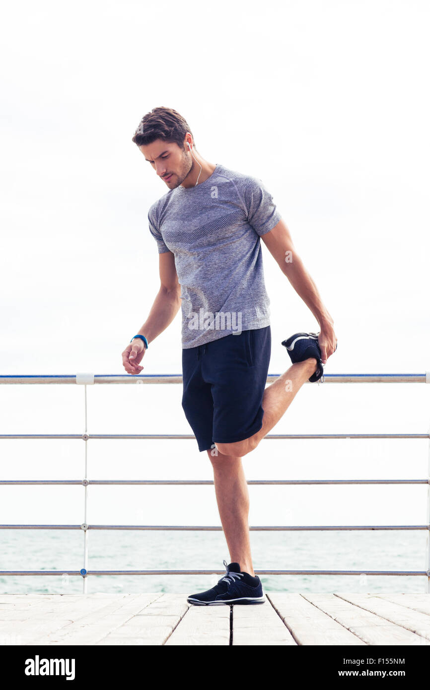 Full length portrait of a handsome man stretching legs outdoors Stock ...