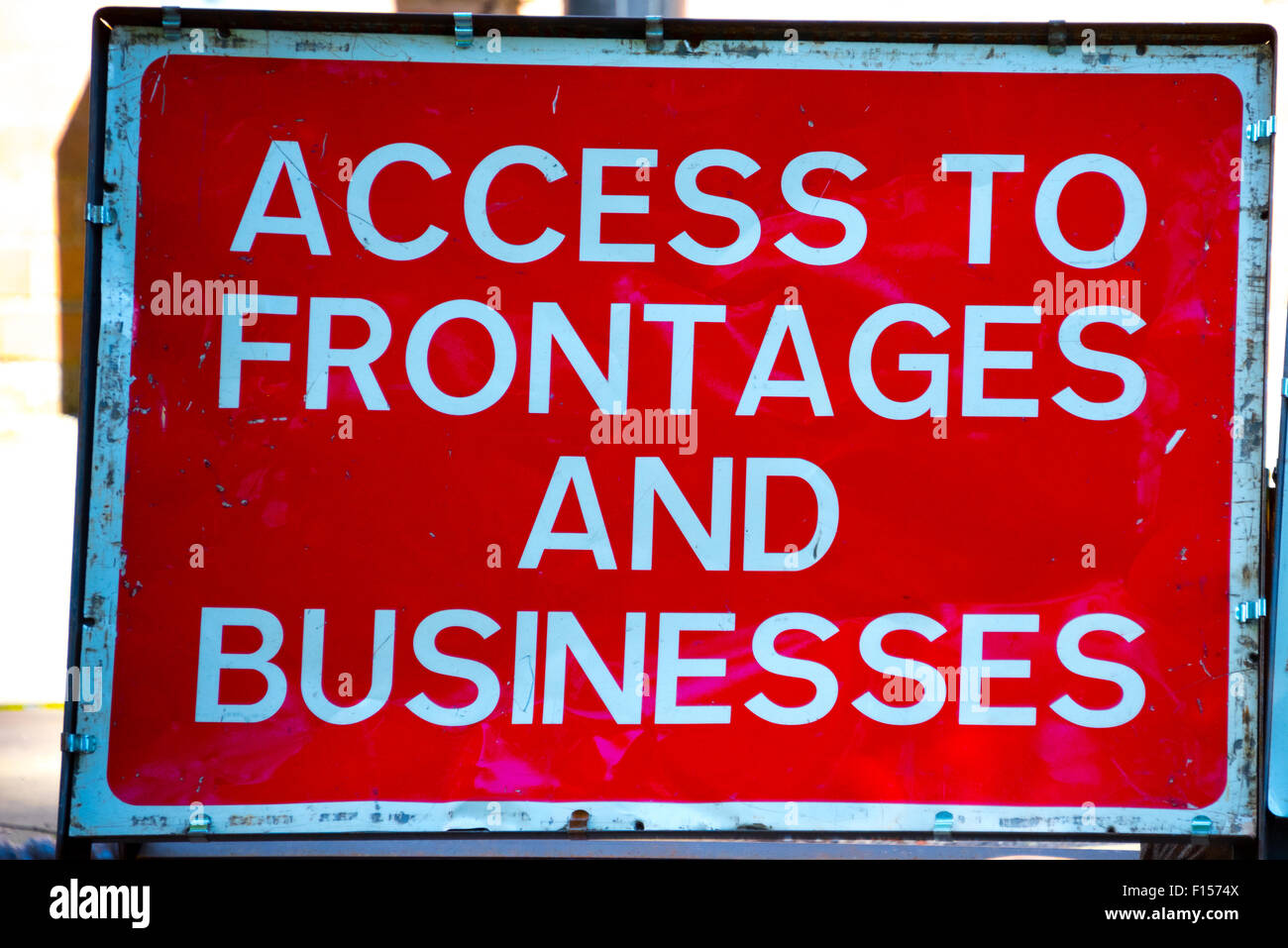 An Access to Frontages and Businesses road sign on a street in ...