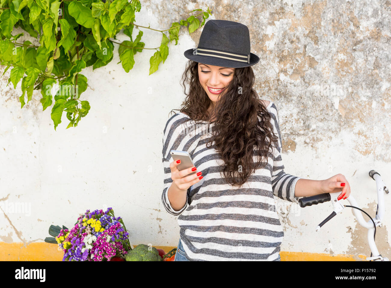 A beautiful young woman sending a text message Stock Photo - Alamy